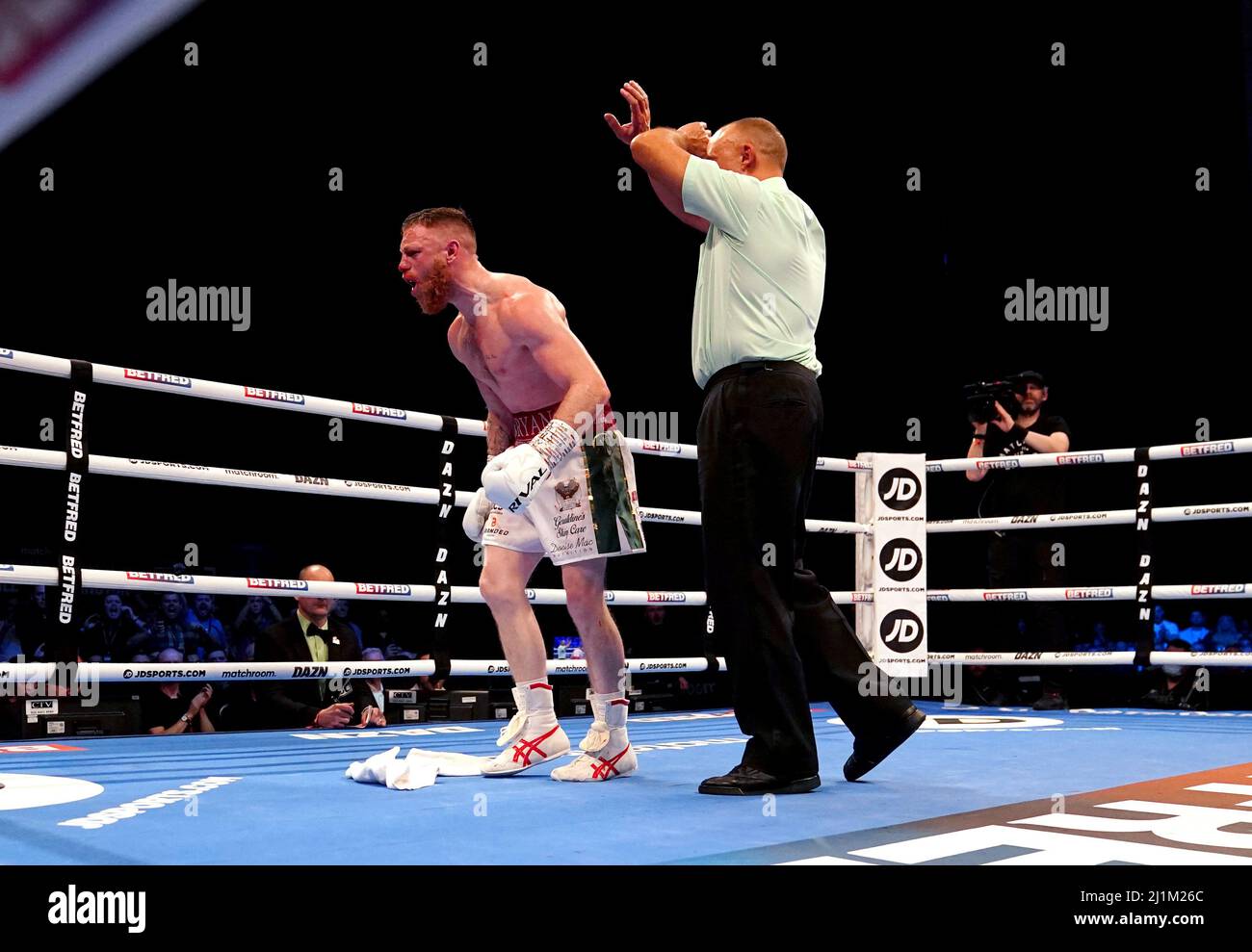 Ray Moylette (left) reacts after his team throw in the towel during his ...
