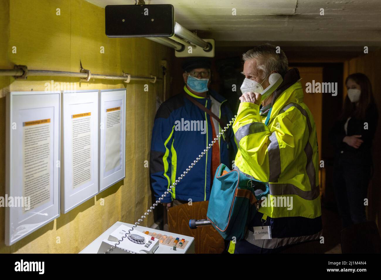 Gosen, Germany. 26th Mar, 2022. A guide lifts the telephone receiver of ...