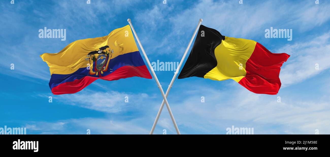 two crossed flags Ecuador and Belgium waving in wind at cloudy sky ...