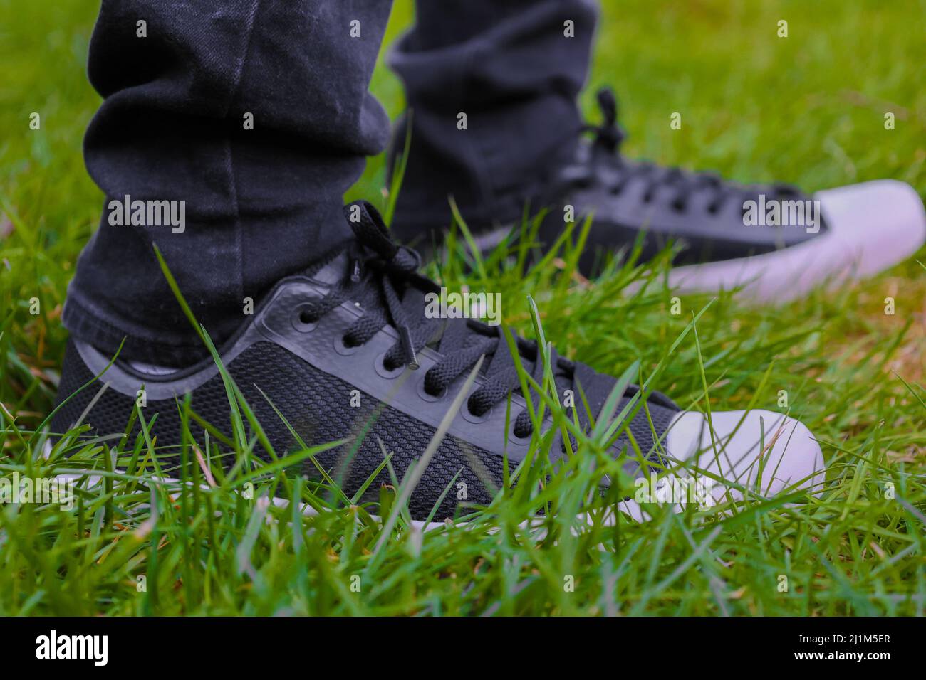 Someone wearing a pair of shows that have white lining with a black ...