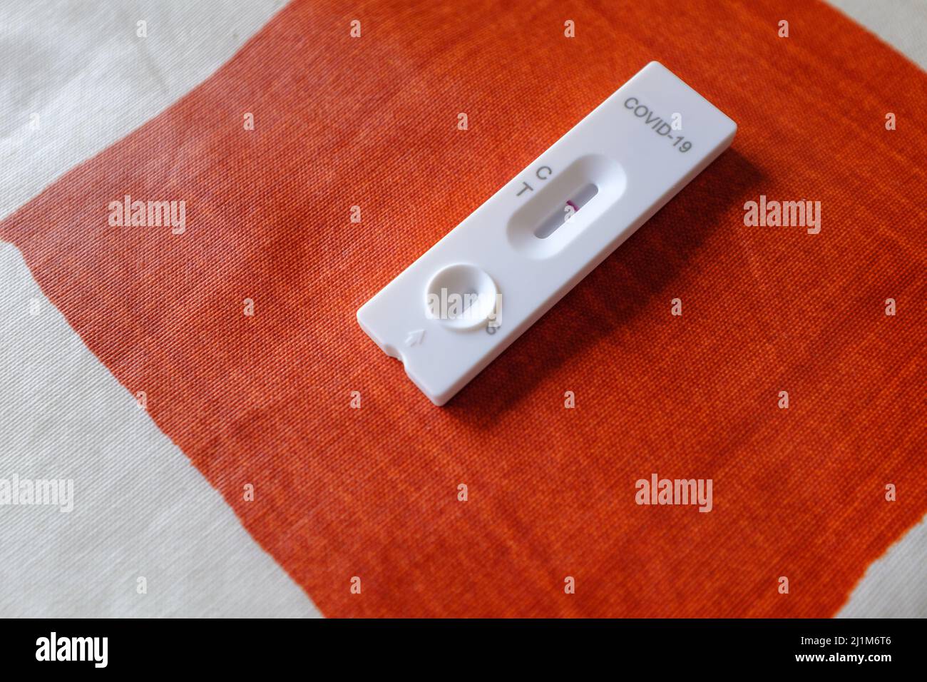 Negative Covid antigen test close up still on a red background close up ...