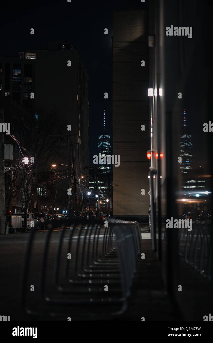A vertical shot of an urban area with lit-up high buildings in the ...