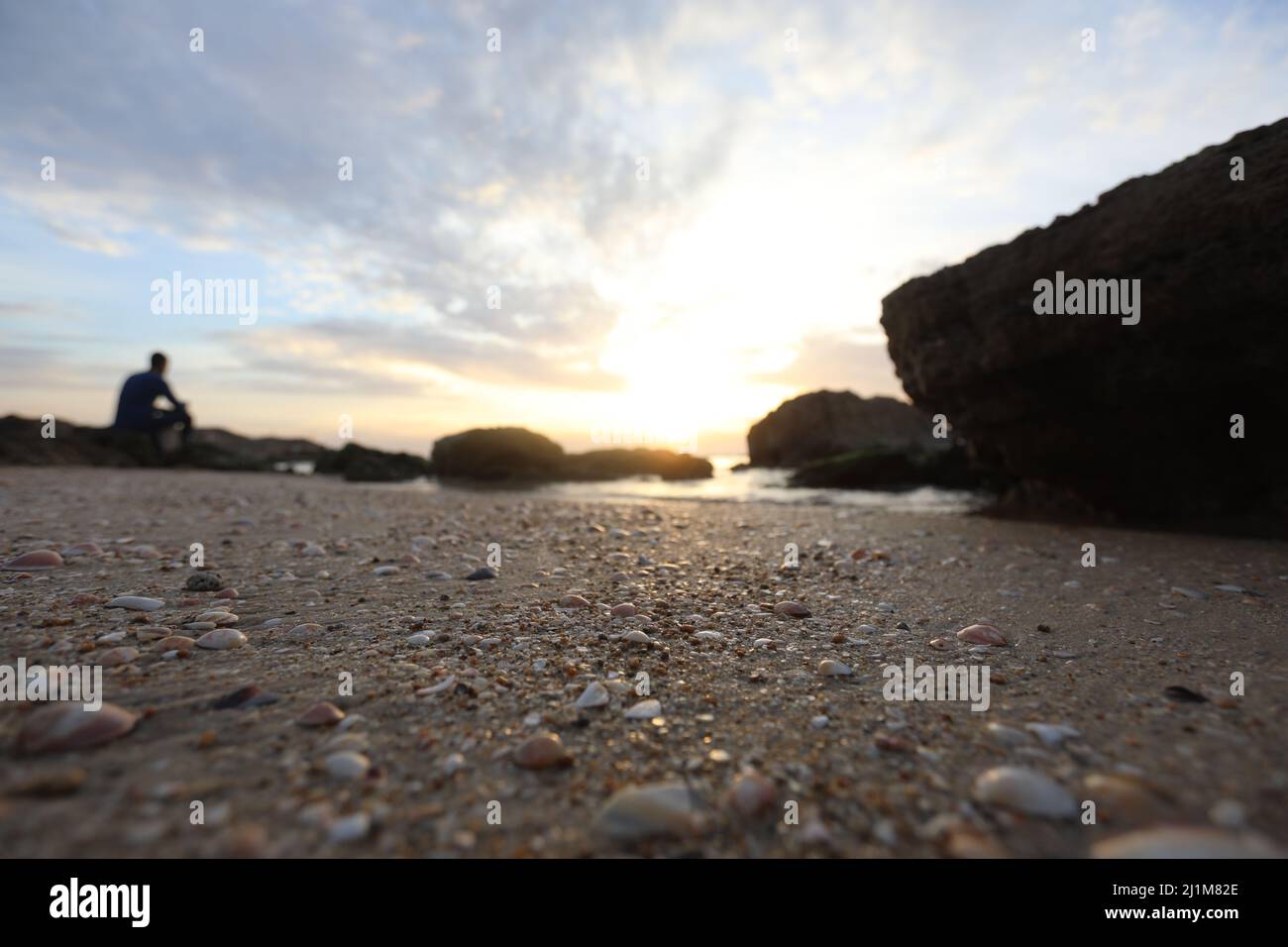 Man alone in the sea lonely feeling sunset time Stock Photo - Alamy