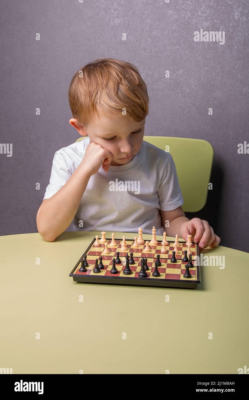 a little boy is playing chess Stock Photo - Alamy