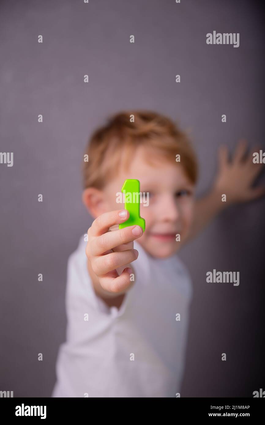 The number 1 in the hands of a child Stock Photo - Alamy