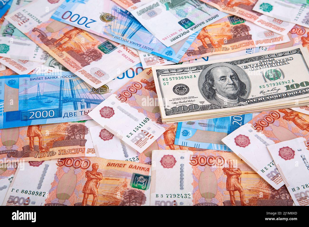 a pack of hundred-dollar bills is on Russian rubles of different ...