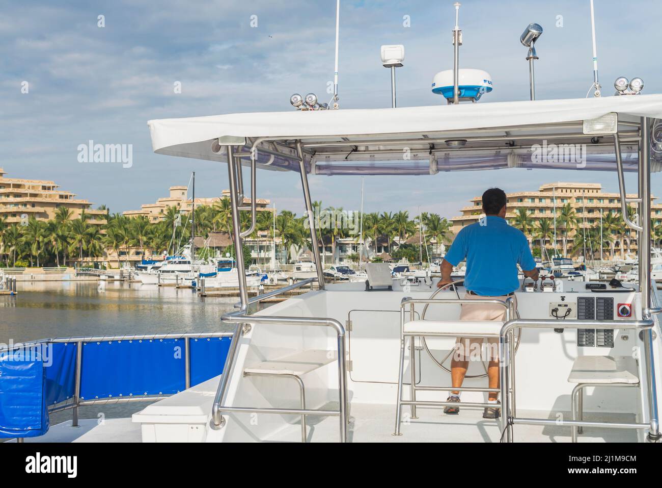 Latin captain navigating a tour boat ready to depart for work Stock ...