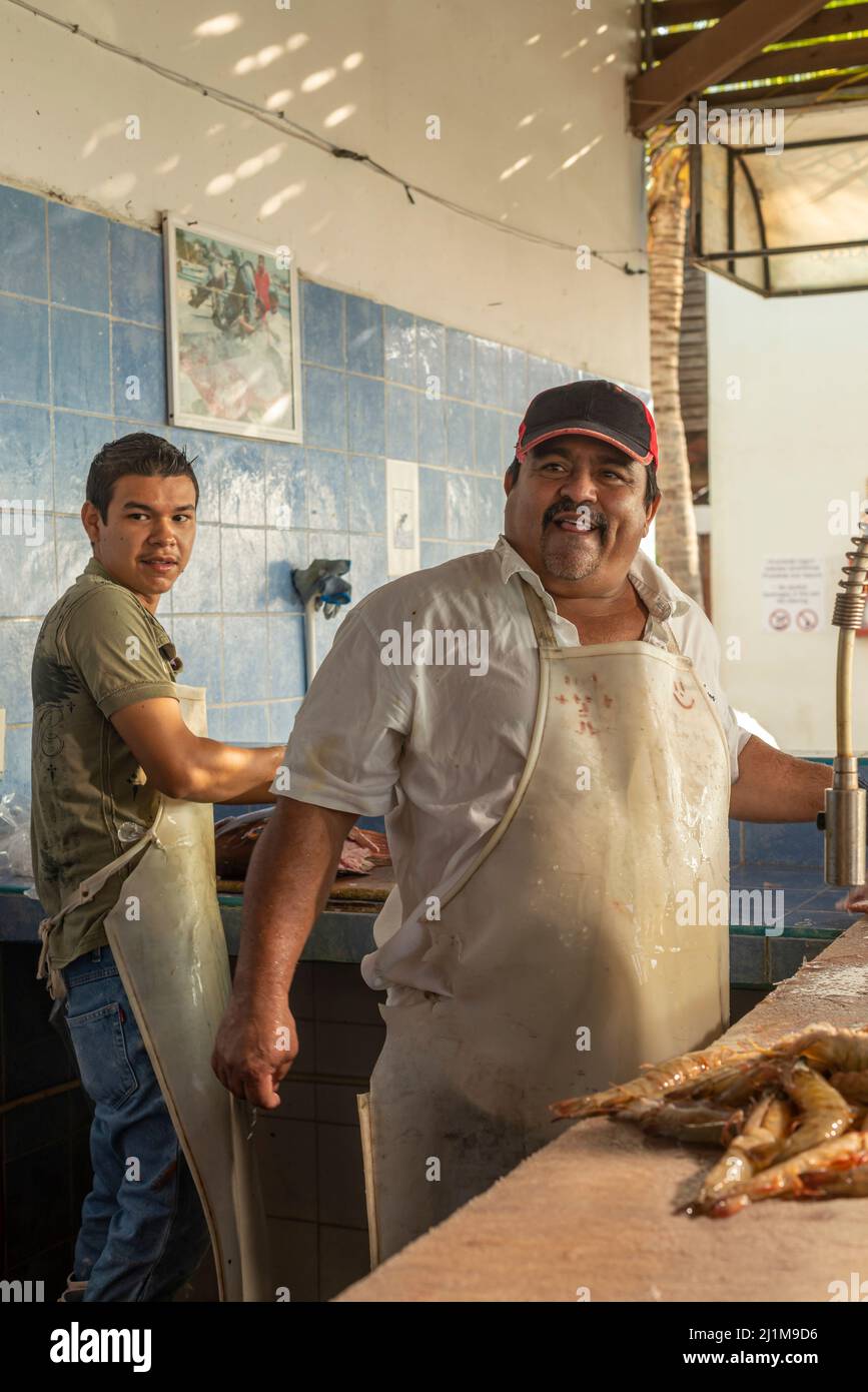 Portrait of latin butchers working at the local fish market Stock Photo ...