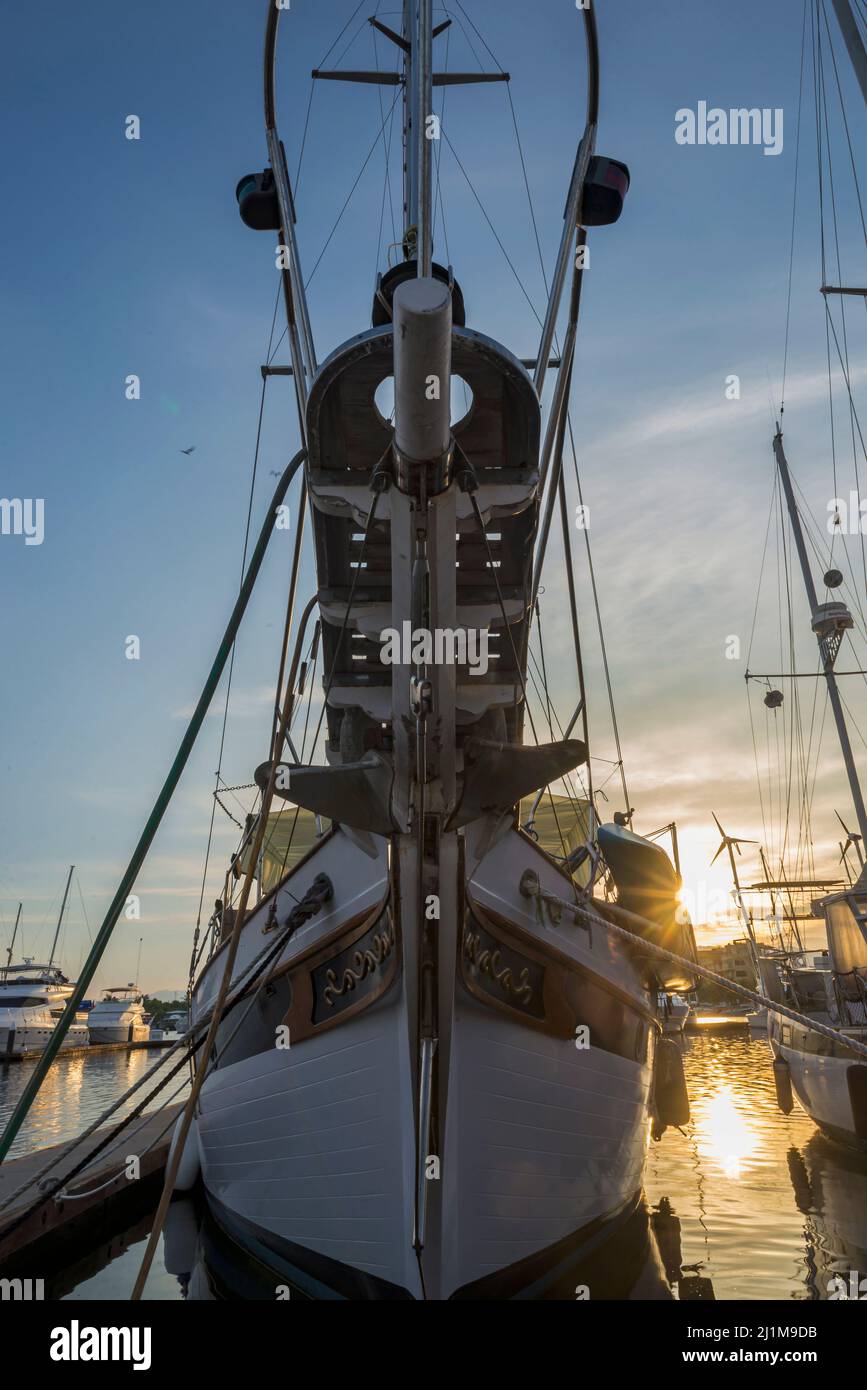 Close up of the front of a sailboat moored at the marina at sunrise ...
