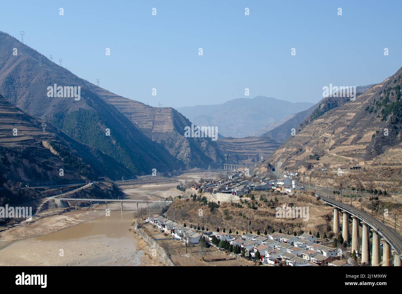 An aerial shot of an industrial countryside with a railway bridge in ...