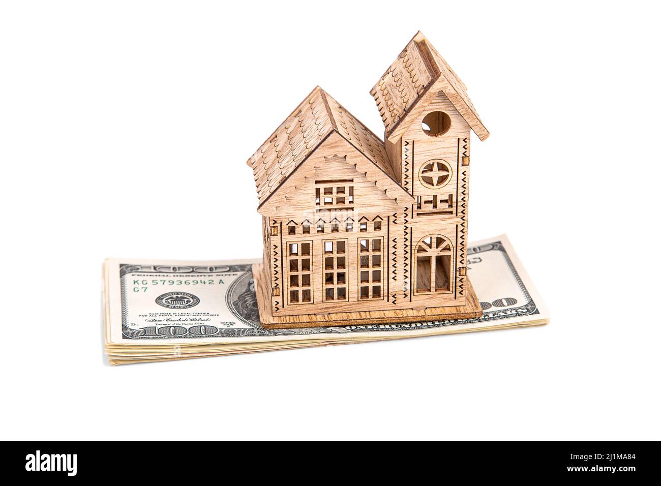 Wooden house on a stack of dollars on a white background Stock Photo ...
