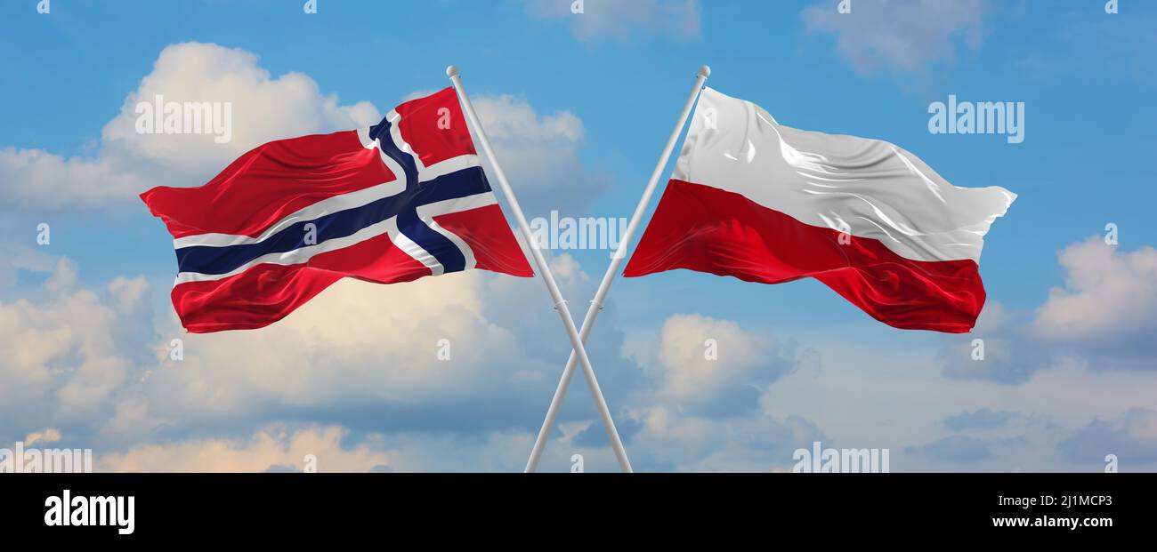 two crossed flags Norway and Poland waving in wind at cloudy sky ...