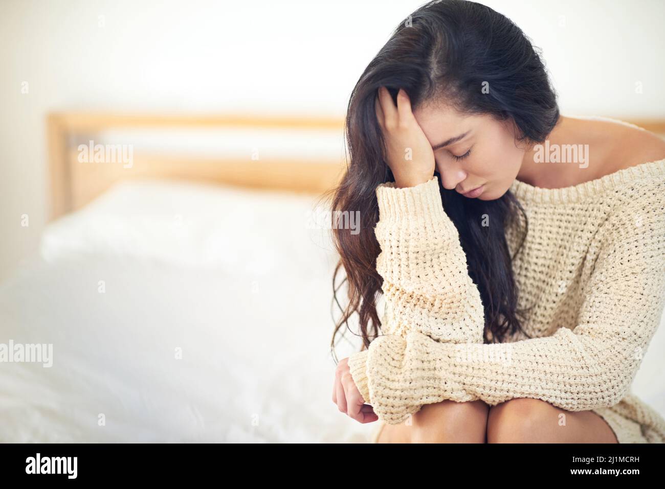 Shes going through a lot. Cropped shot of a young woman looking ...