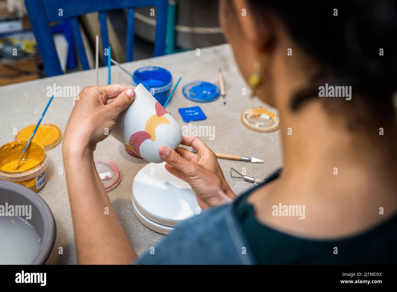 women's hands painting a pottery object Stock Photo - Alamy