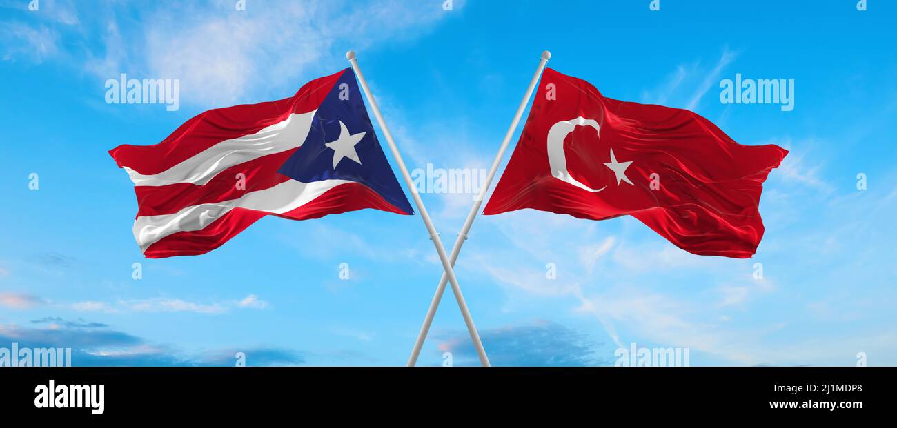 two crossed flags Puerto Rico and Turkey waving in wind at cloudy sky. Concept of relationship ...