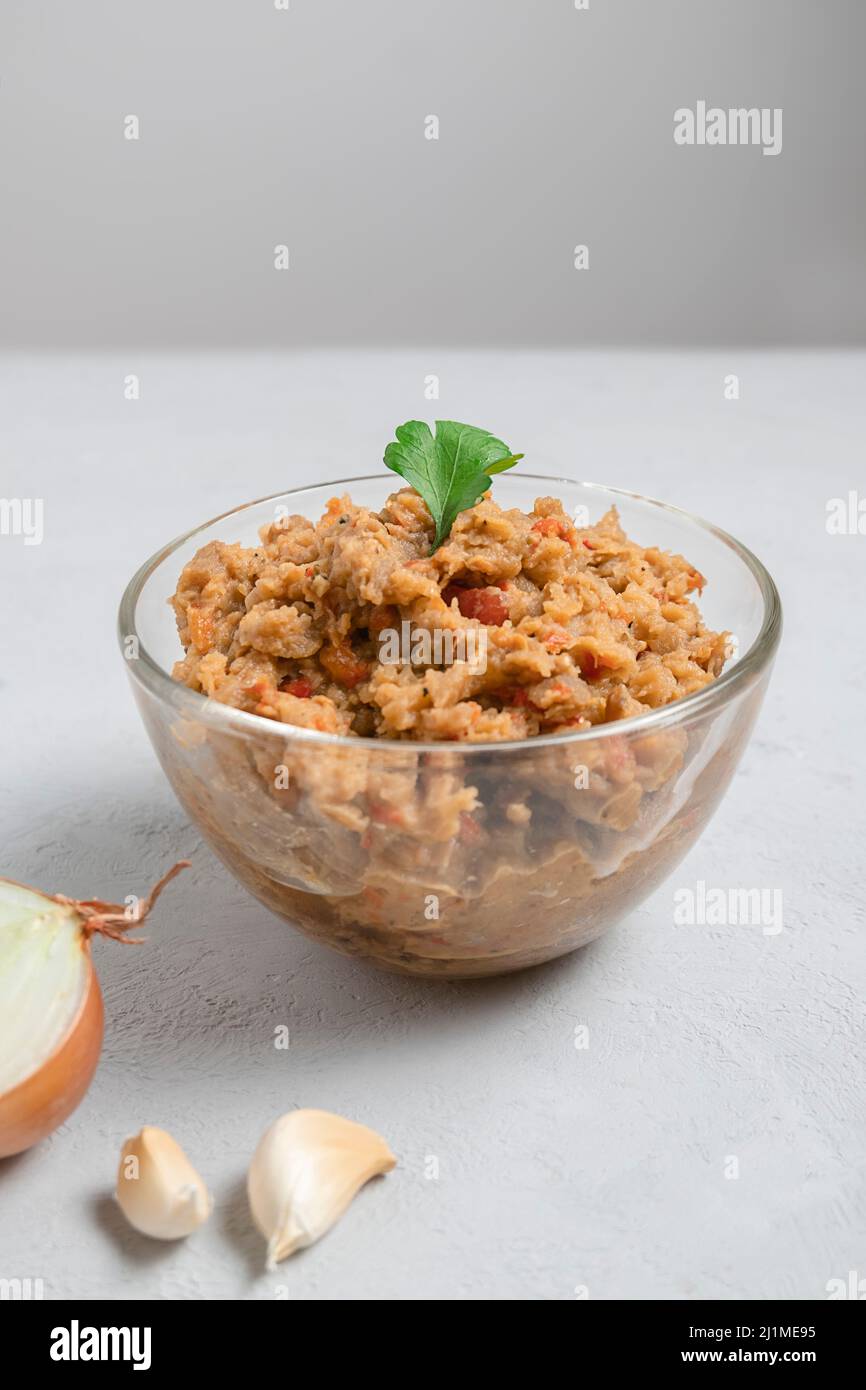 Vegetarian eggplant dip Kiopoolu in a glass jar on neutral grey ...
