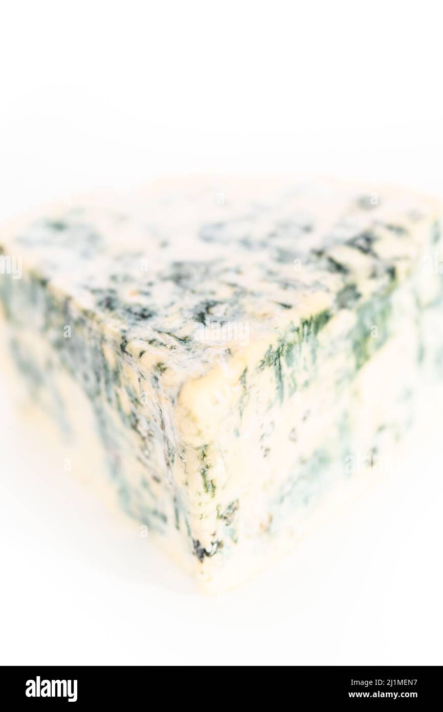 Large slice of blue cheese on a white background Stock Photo - Alamy