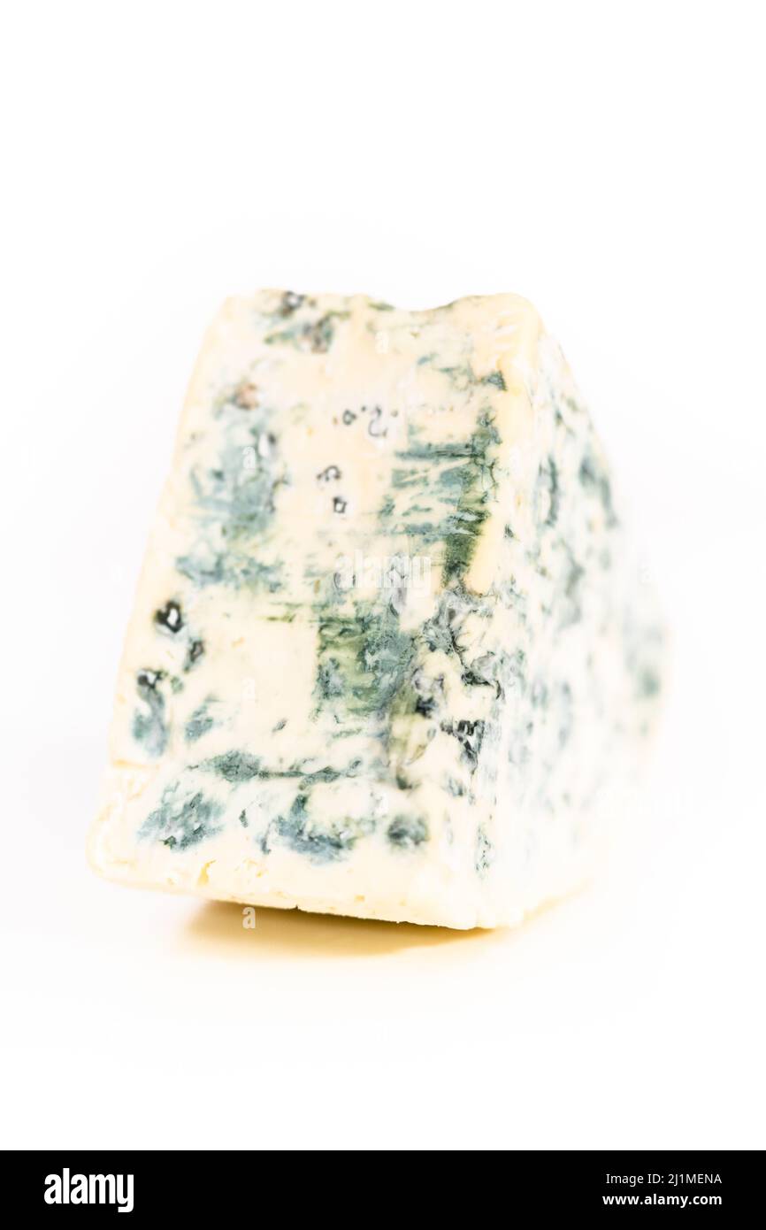 Large slice of blue cheese on a white background Stock Photo - Alamy
