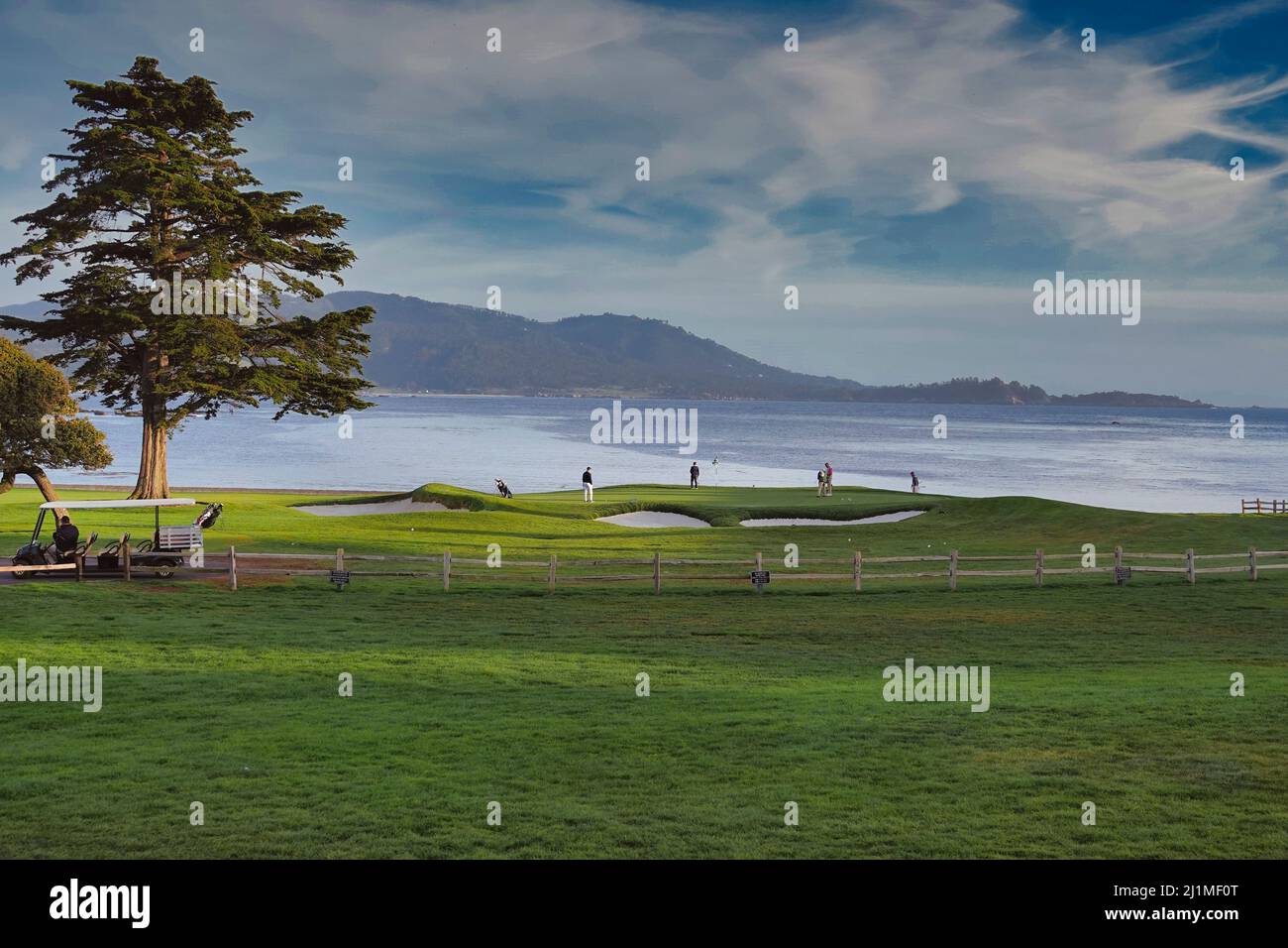 Players tackle the 18th green on the world famous Pebble Beach Golf ...