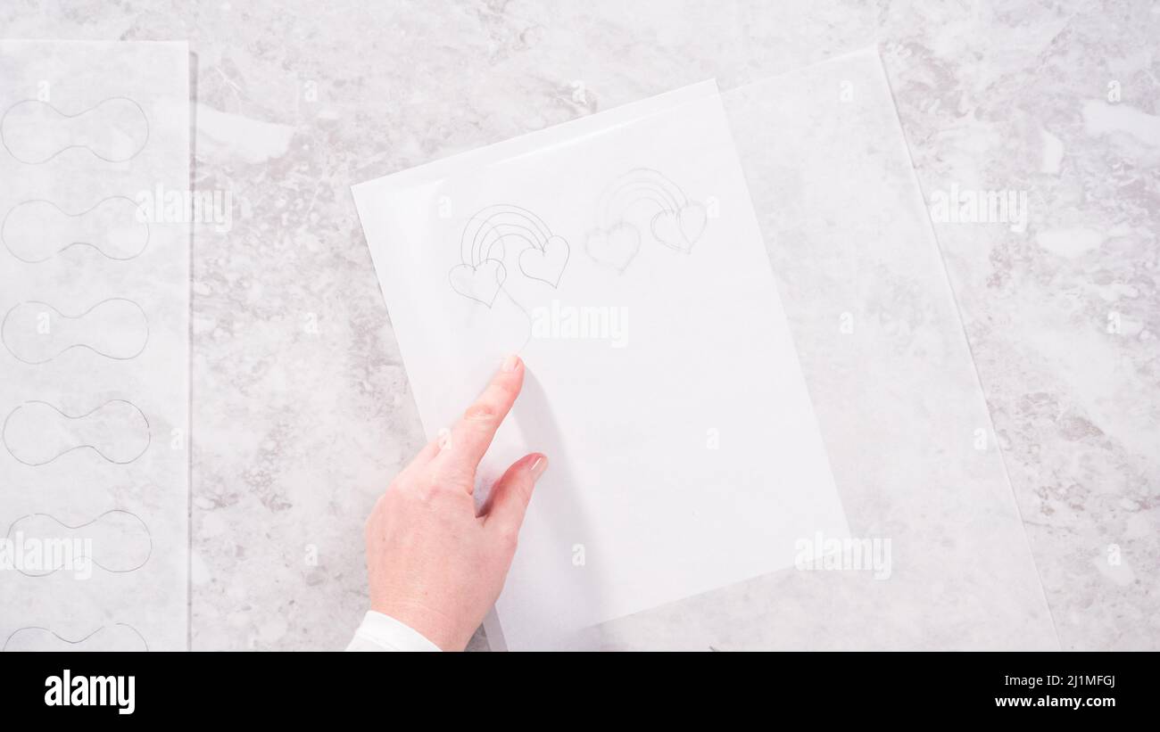 Flat lay. Step by step. Drawing outlines with pencil on parchment paper ...