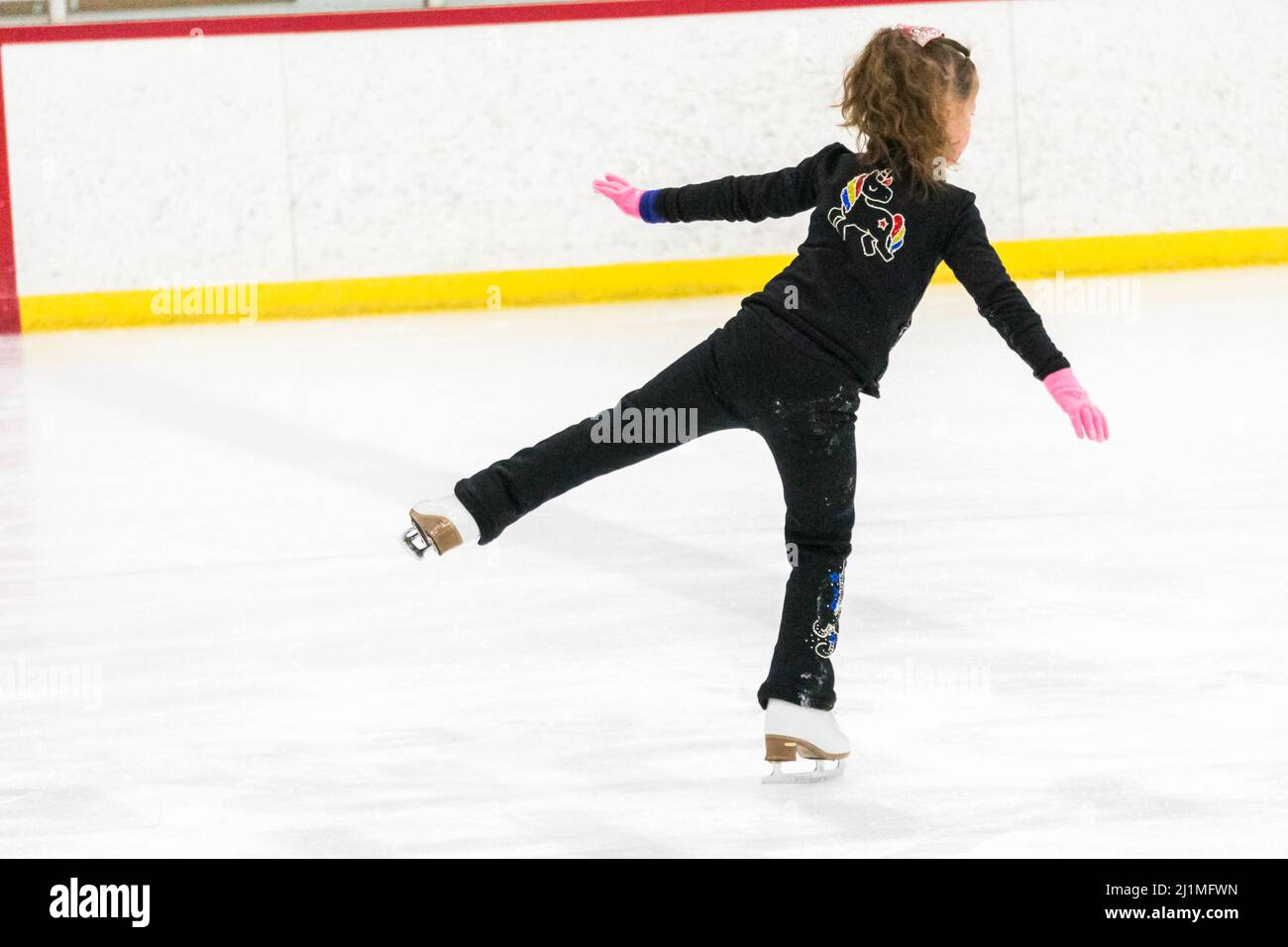 Little skater practicing her elements at the morning figure skating ...