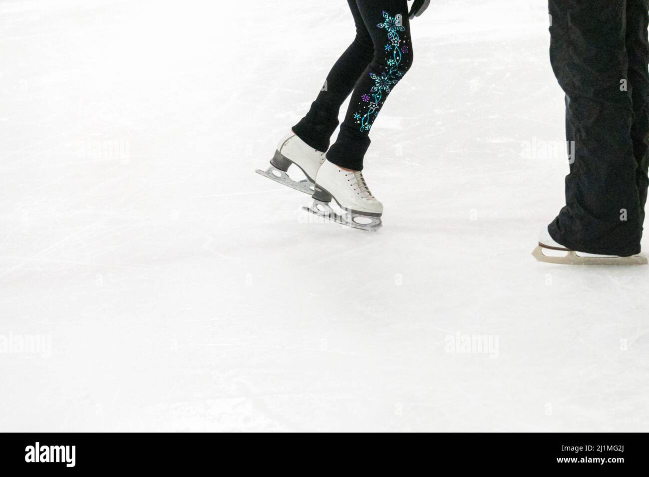 View of a figure skater and her coach feet at the figure skating ...