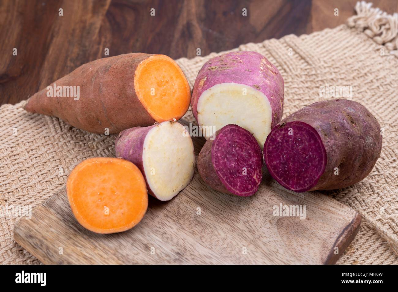 Colorful root vegetables pink, purple and orange organic sweet potatos ...