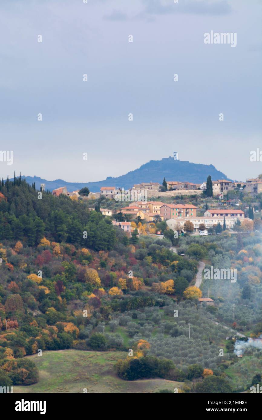 Colorful tuscan hills in autumn, Medieval fortification castle on ...