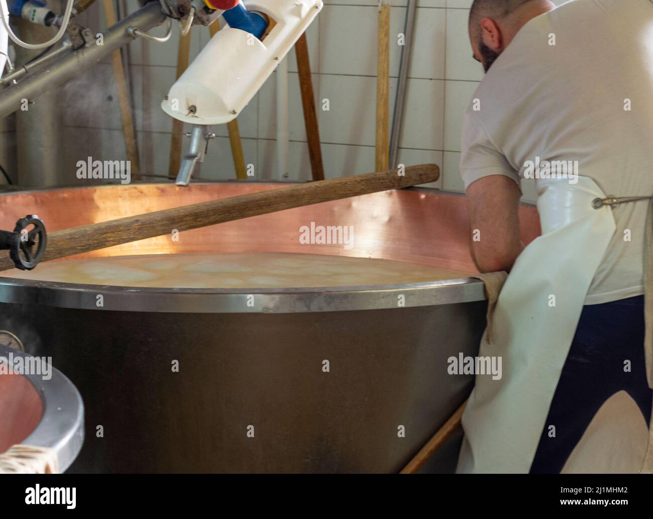Traditional process of making from cow milk wheels of parmigiano ...
