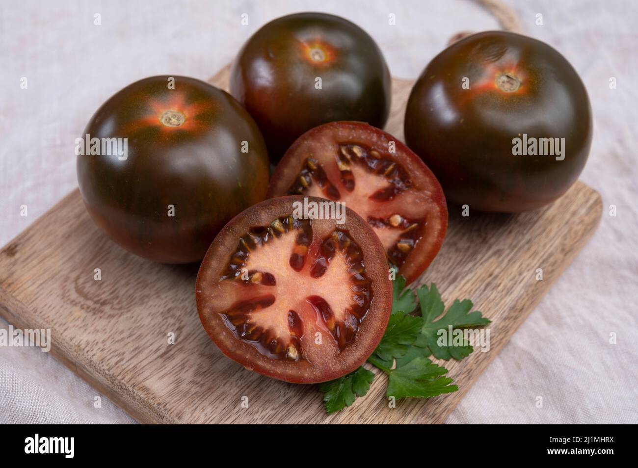 Healthy vegetarian food, reddish brown sweet kumato tomatoes close up ...