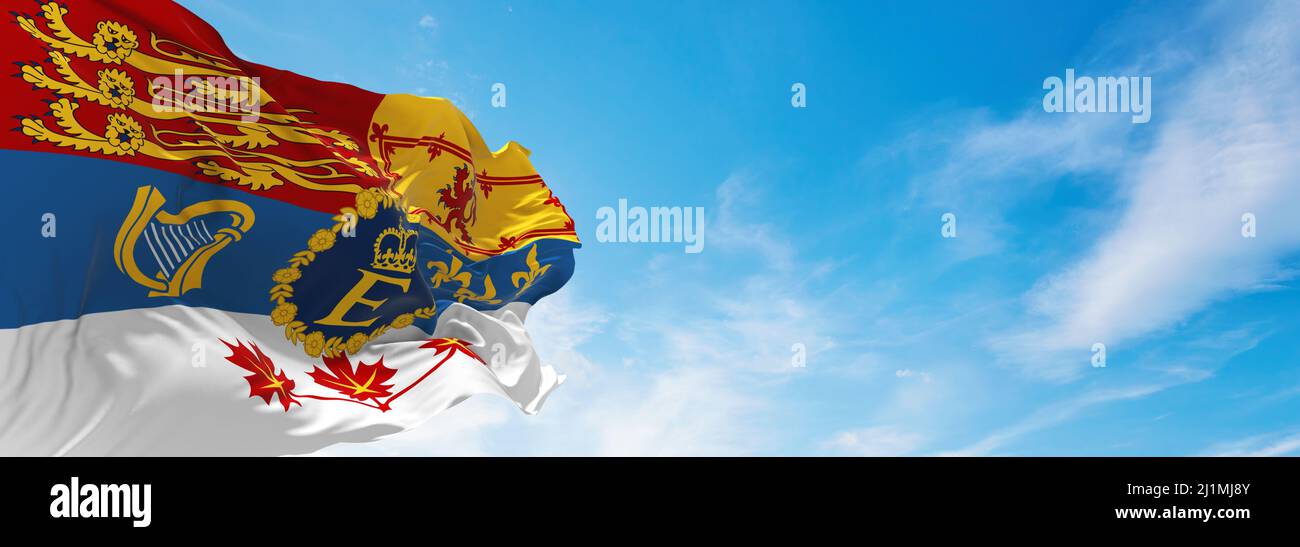 flag of Royal Standard of Canada , Canada at cloudy sky background on ...