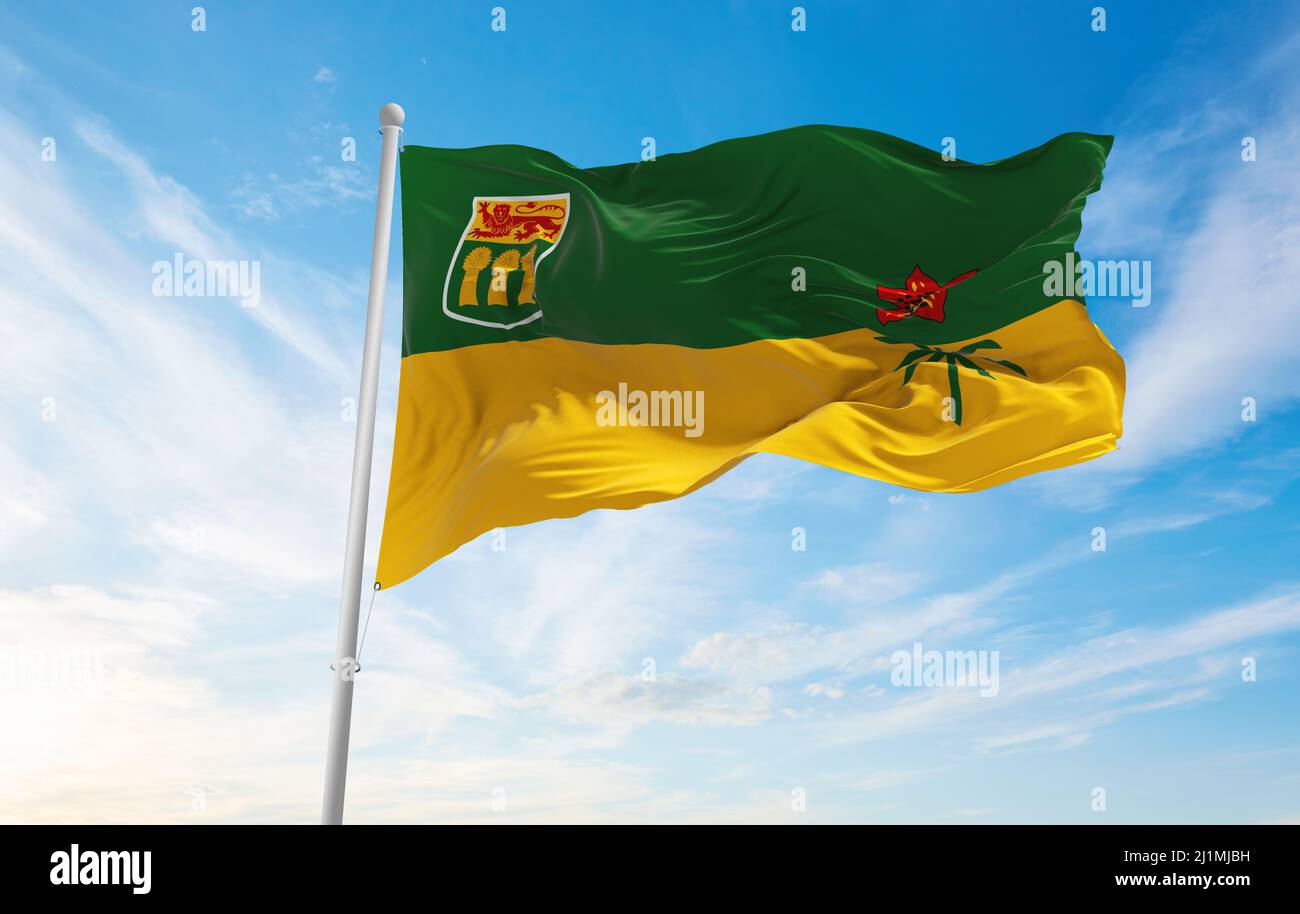 flag of Saskatchewan , Canada at cloudy sky background on sunset ...