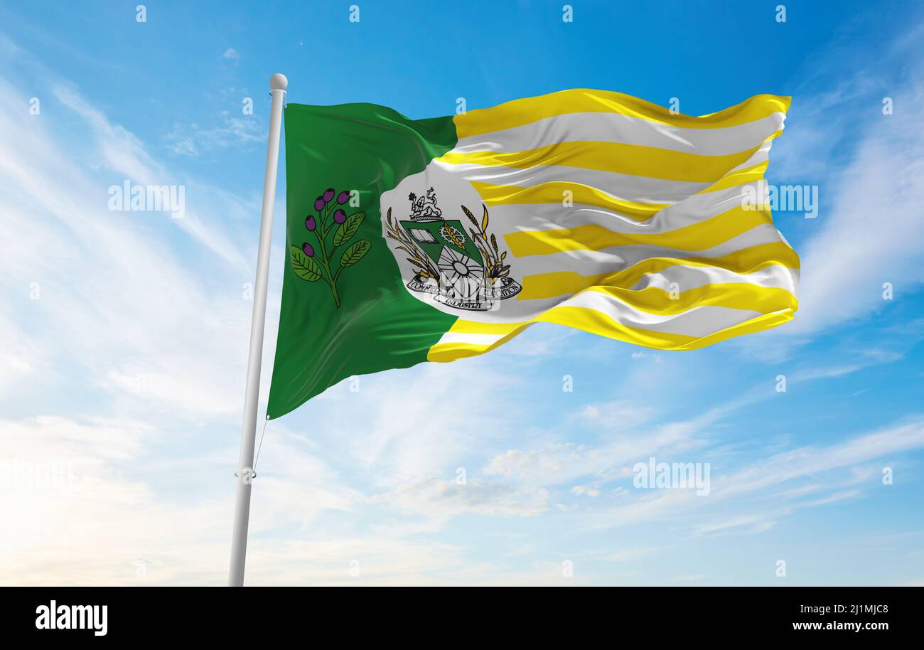flag of Saskatoon , Canada at cloudy sky background on sunset ...