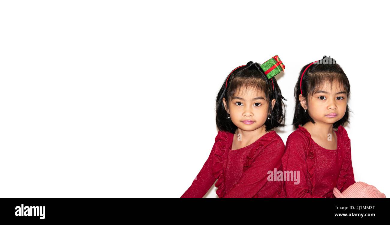 Portrait of cute twins back to back to each other on white background ...