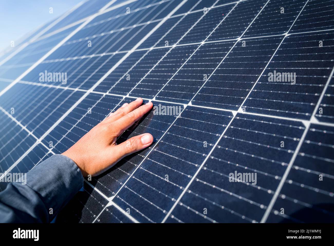 Man hand touching the solar panel, hot climate causes increased power ...