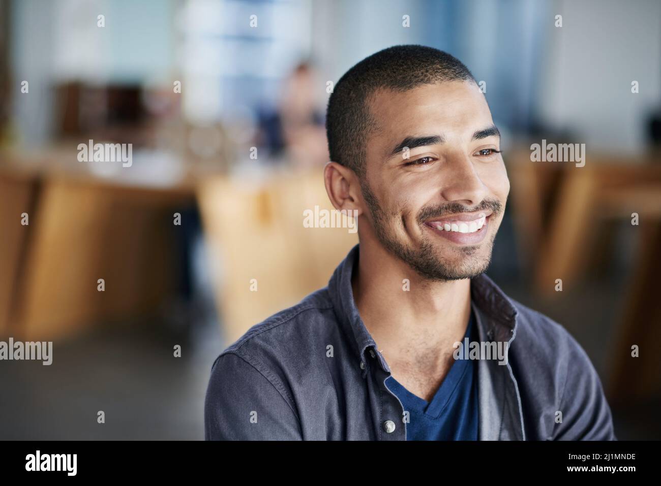 Best job ever. Shot of a happy-looking office worker Stock Photo - Alamy