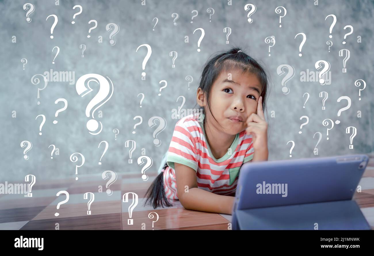 Asian little girl thinking with a question mark symbol in gray ...