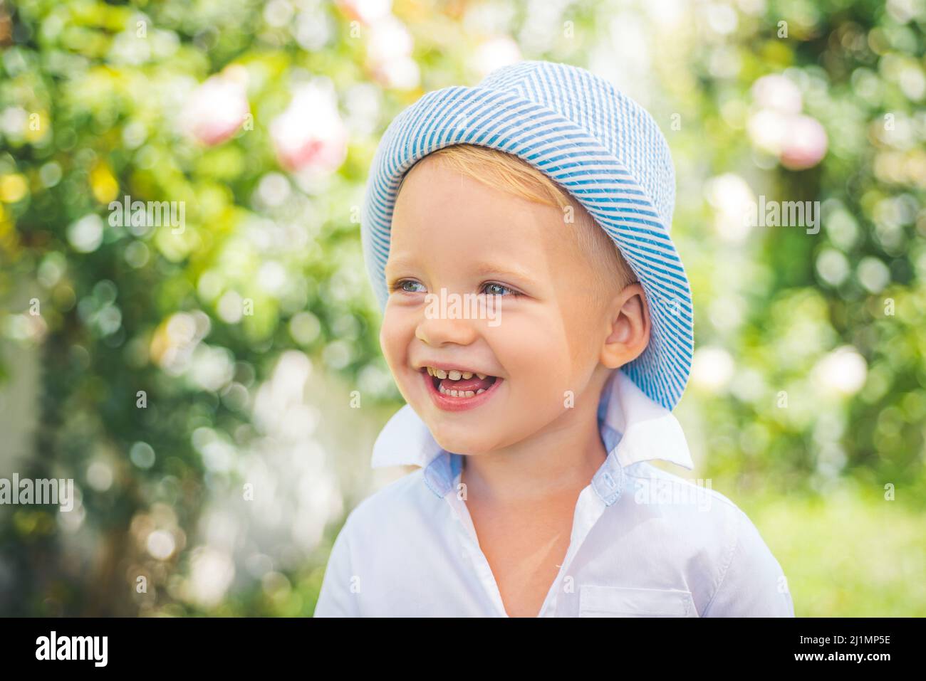 Close up portrait of cute boy smiling outdoors. Closeup headshot ...
