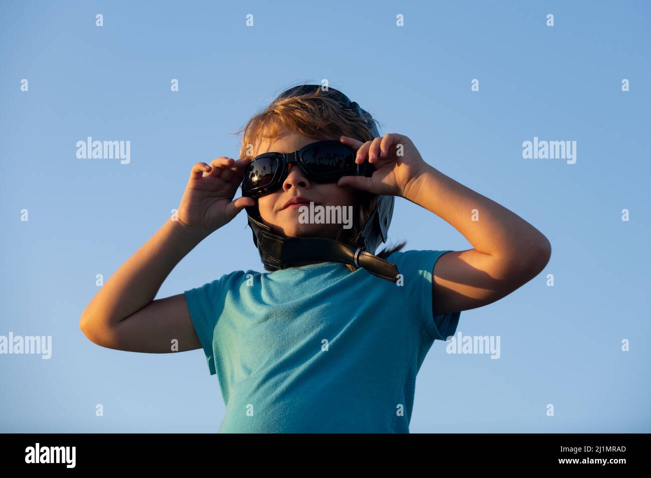 Little boy with pilot goggles and helmet, boy wants to become pilot and ...