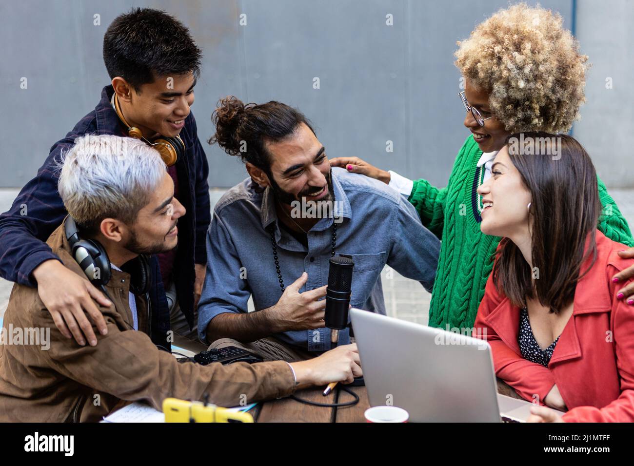 Multiracial diverse student friends doing homework together while using ...