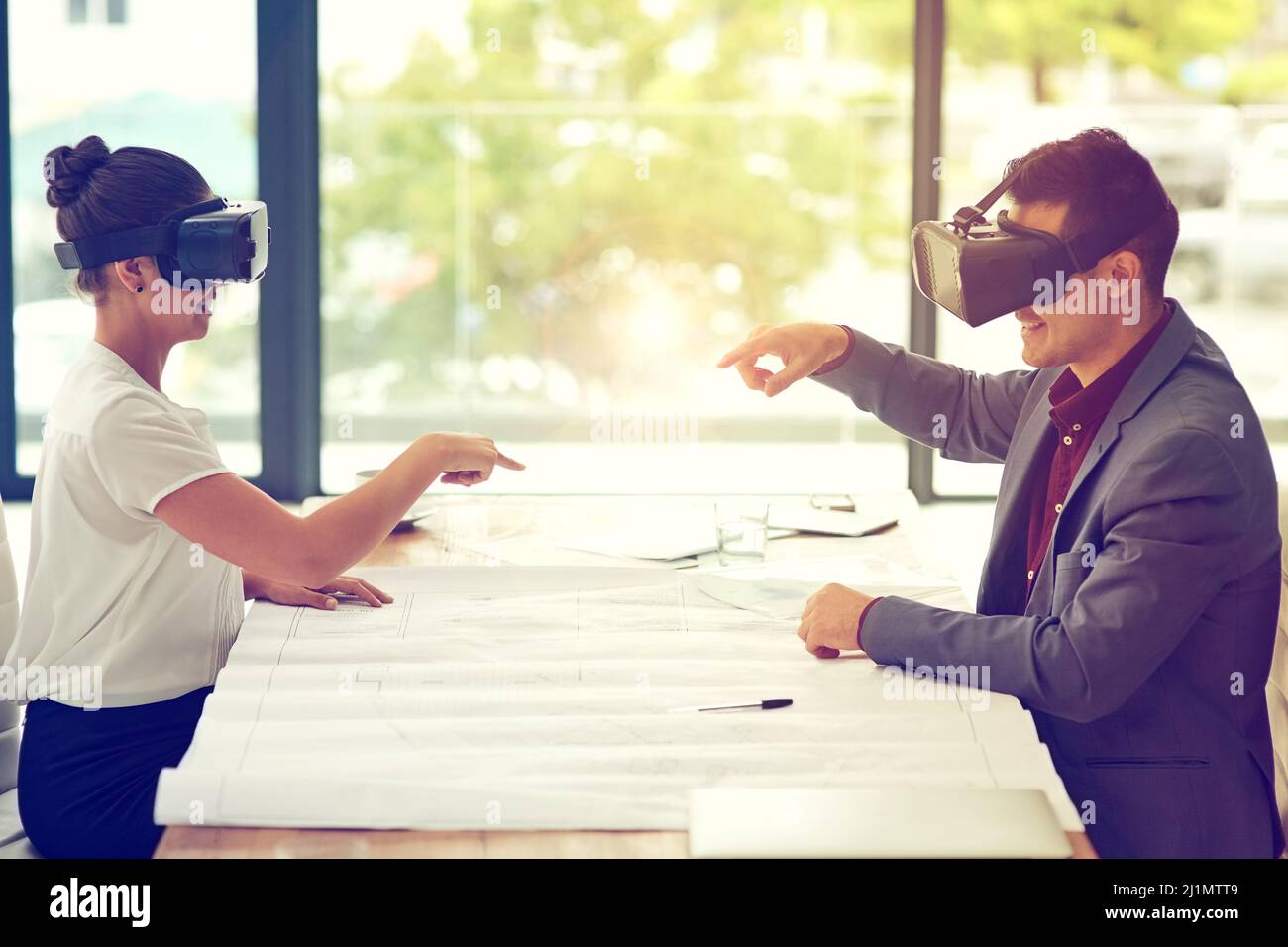 Designing the future together. Shot of two businesspeople wearing VR ...