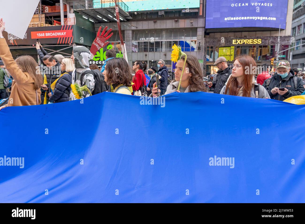 NEW YORK, NEW YORK - MARCH 26: Women hold sunflower, Ukraine's national ...