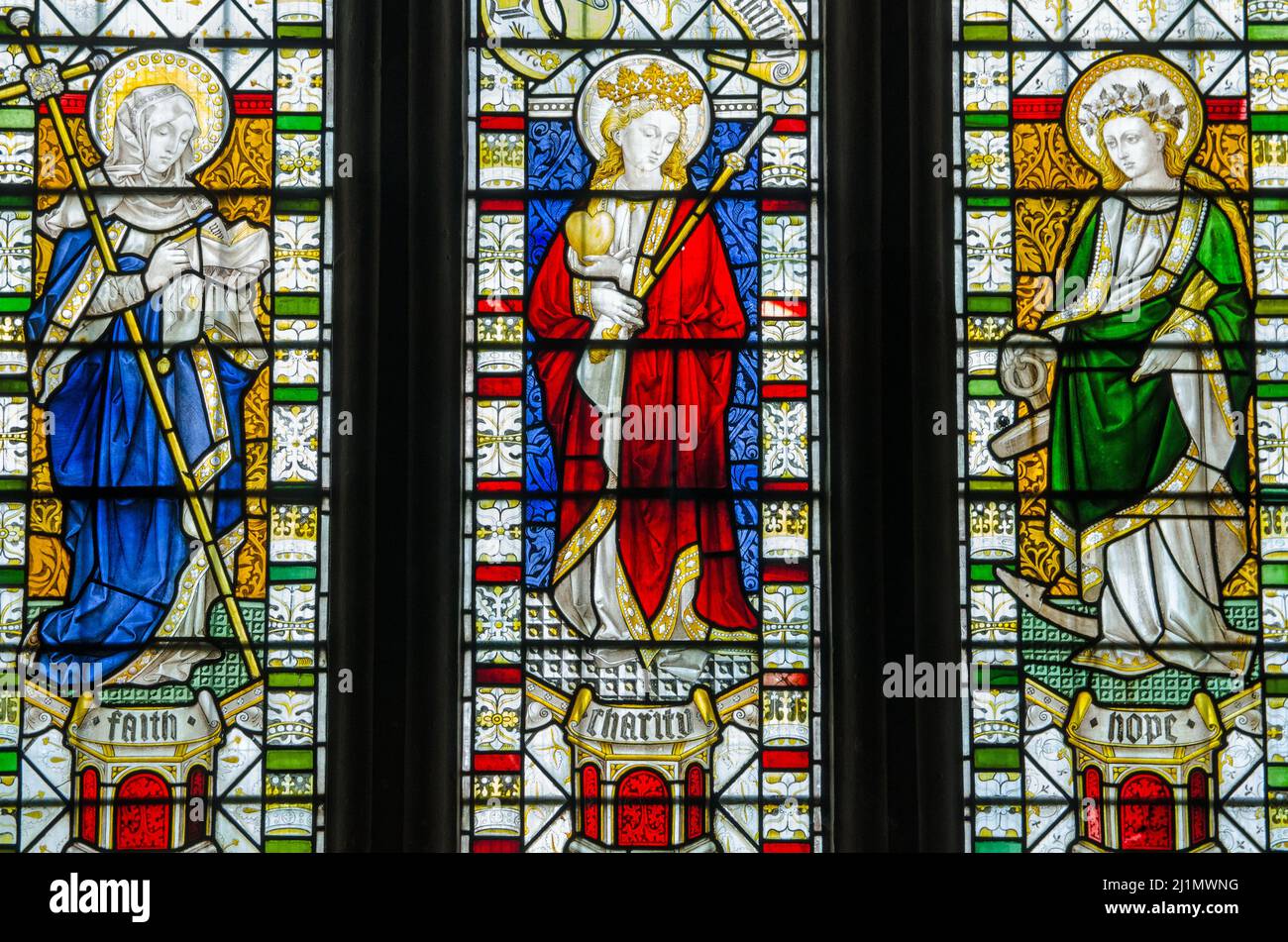 A Victorian stained glass window showing the three theological virtues ...