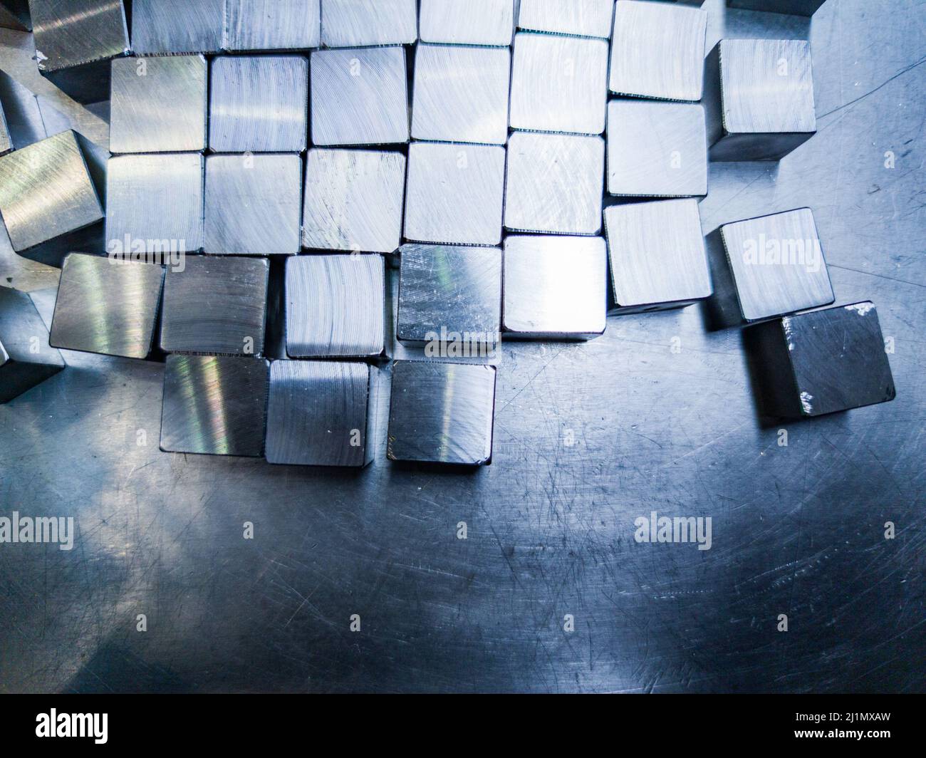 pile of small machined shiny steel cubes on metal surface Stock Photo ...