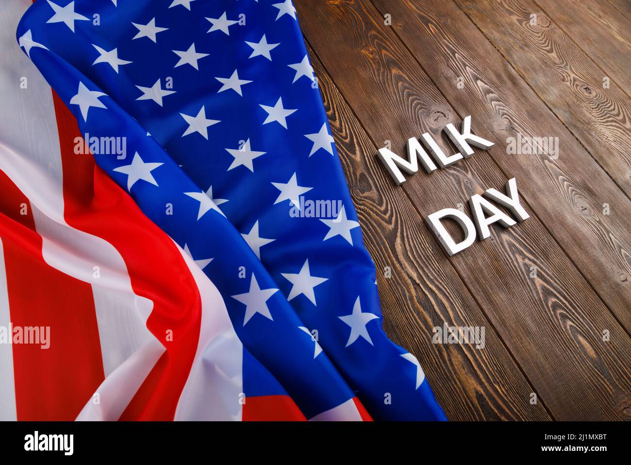 the word MLK day laid with silver metal letters on wooden surface with ...