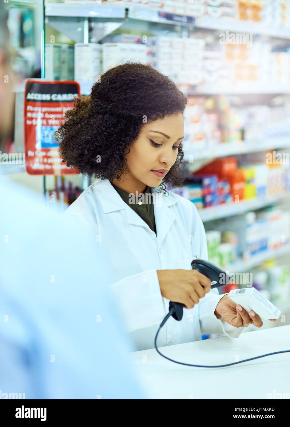 Let me just ring this up for you. Cropped shot of an attractive young ...