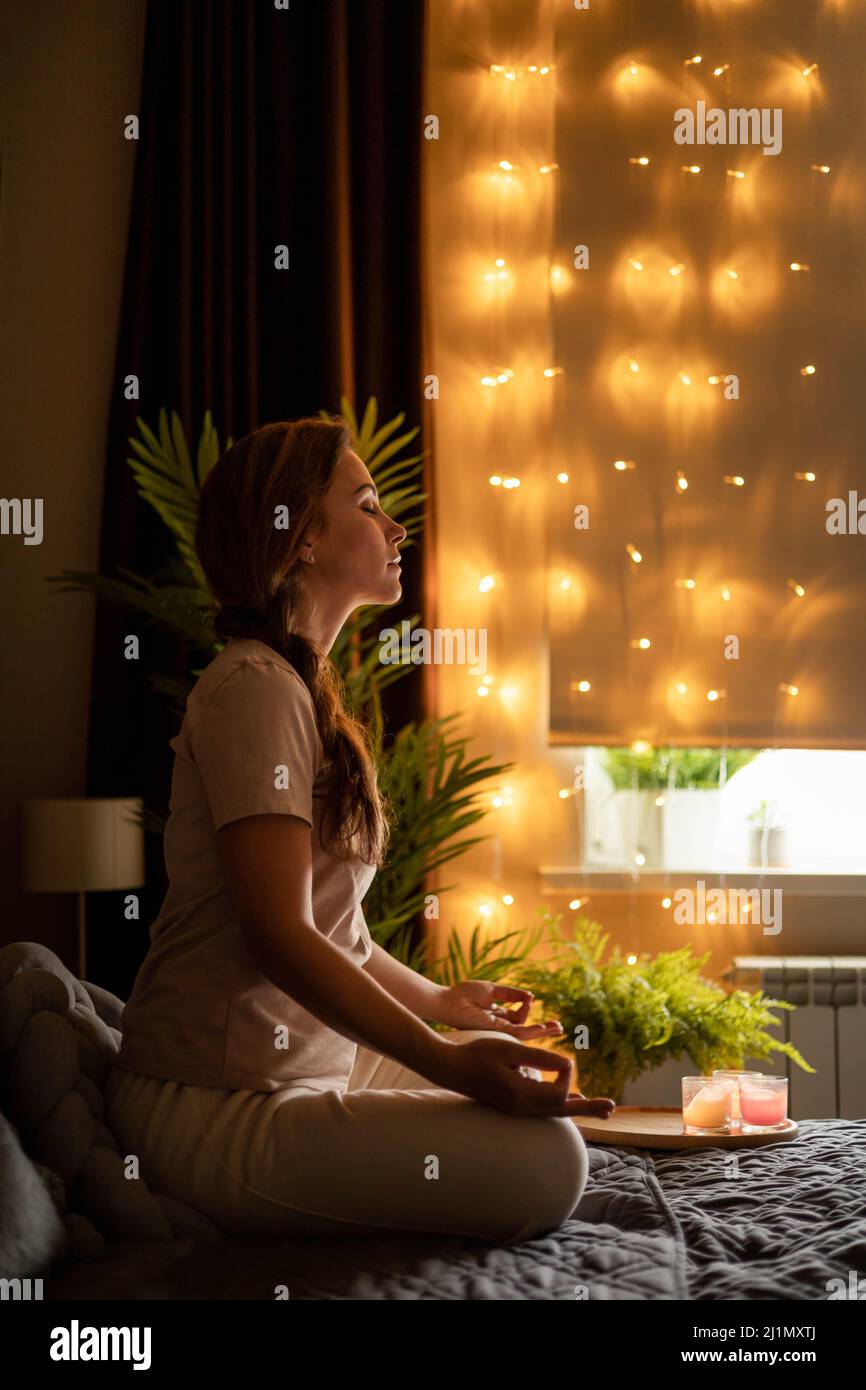 Relaxed yoga woman meditation in lotus position with hands namaste on ...