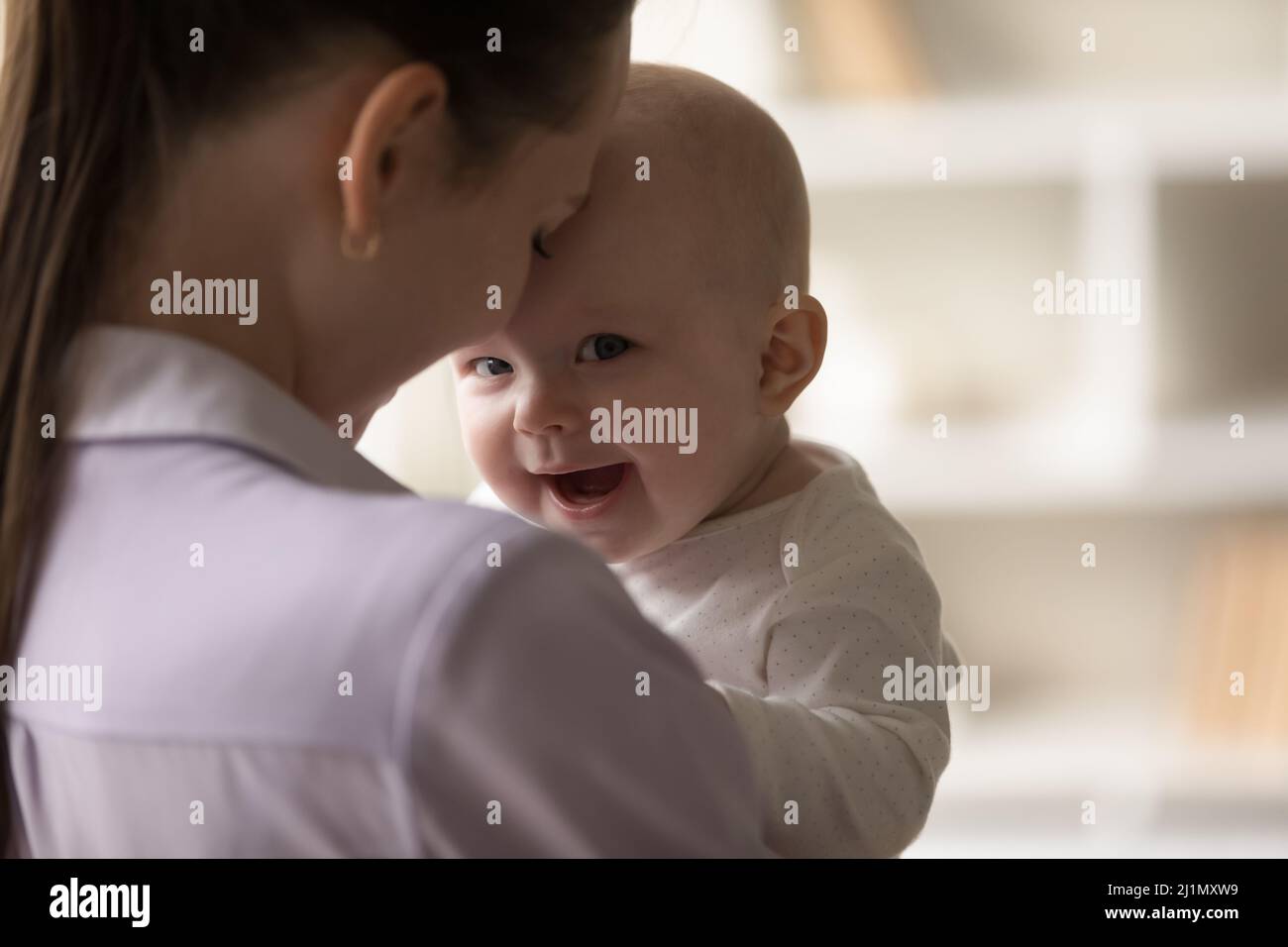 Affectionate young mother holding adorable newborn baby Stock Photo - Alamy