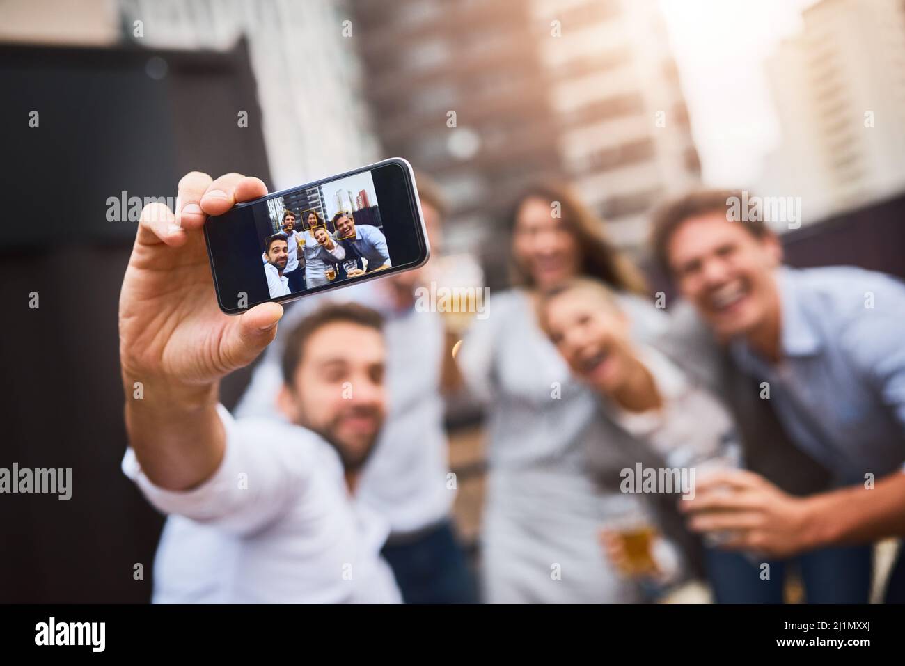 Making memories after work with colleagues. Cropped shot of ...