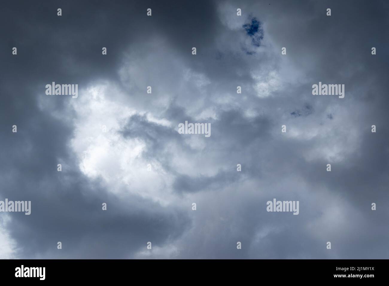 Angry human face glares down from the clouds Stock Photo - Alamy